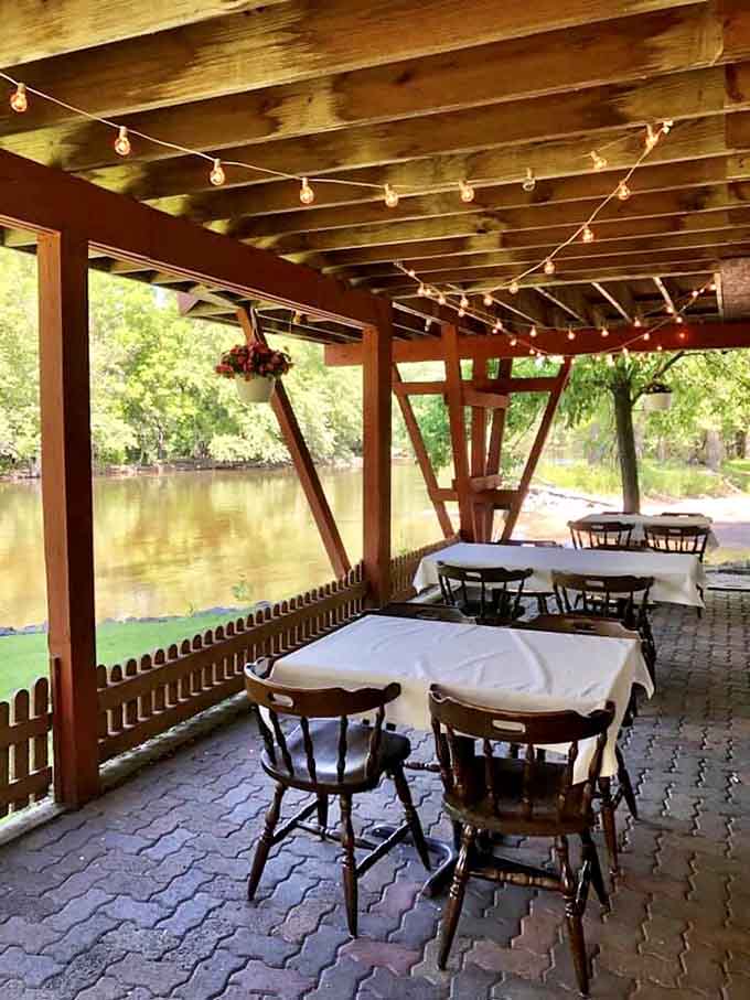 Riverside patio dining under string lights transforms a regular meal into something approaching magical during warm evenings.