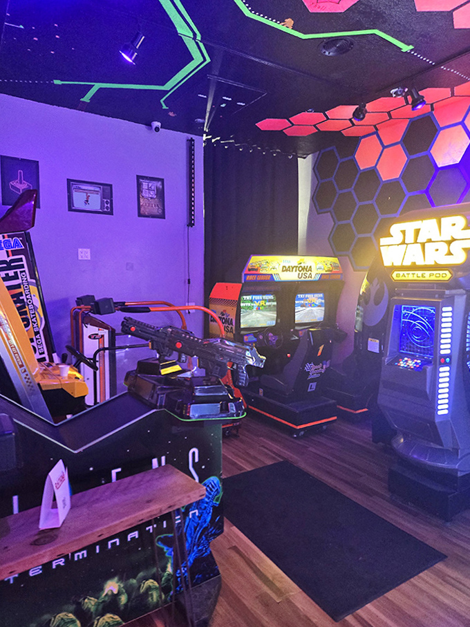 Racing simulators and shooter games create an immersive corner where reality fades faster than quarters from your pocket.