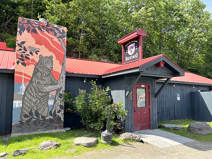 The Backyard's rustic exterior and bear mural hint at the authentic Vermont experience waiting inside &ndash; where locals and visitors mingle freely.