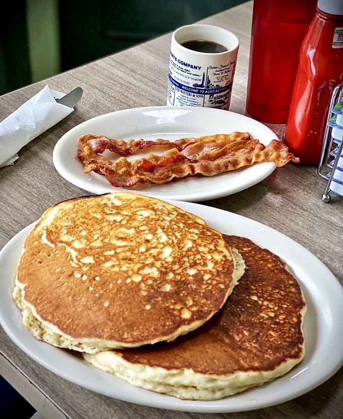 Those pancakes have the perfect golden-brown color that only comes from a well-seasoned griddle and someone who knows exactly what they're doing.