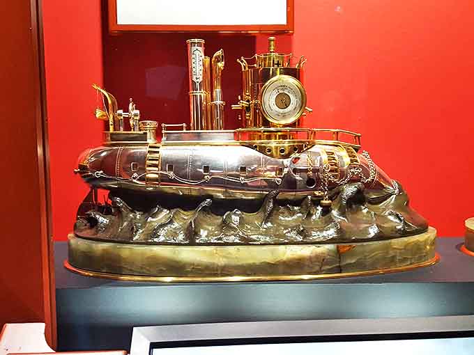 This nautical-themed "battleship clock" combines maritime adventure with timekeeping precision, its brass submarine riding eternal waves of imagination and engineering.