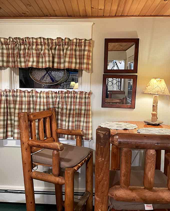 Rustic log furniture and plaid curtains create intimate corners where you can settle in for a long, leisurely meal with good company.