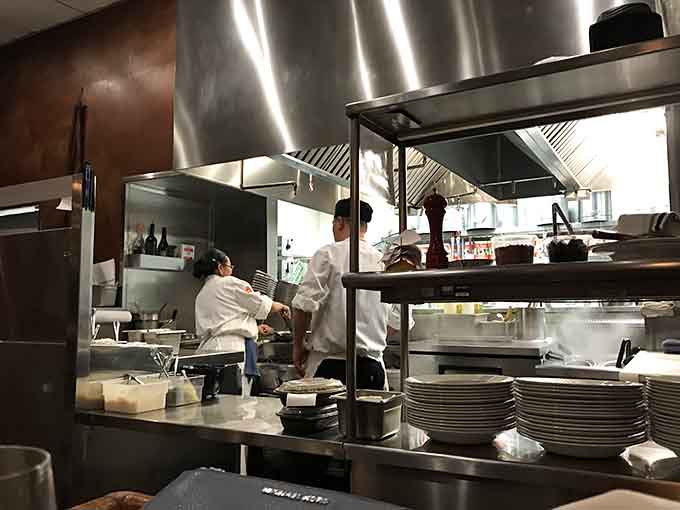 The open kitchen lets you watch skilled chefs transform simple ingredients into extraordinary dishes before your eyes.