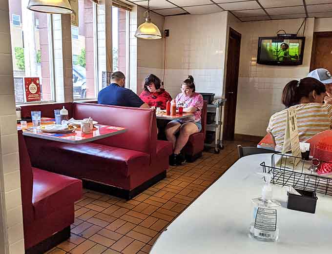 Diners: Red vinyl booths cradle hungry patrons as they dive into plates of breakfast bliss, creating memories one bite at a time.