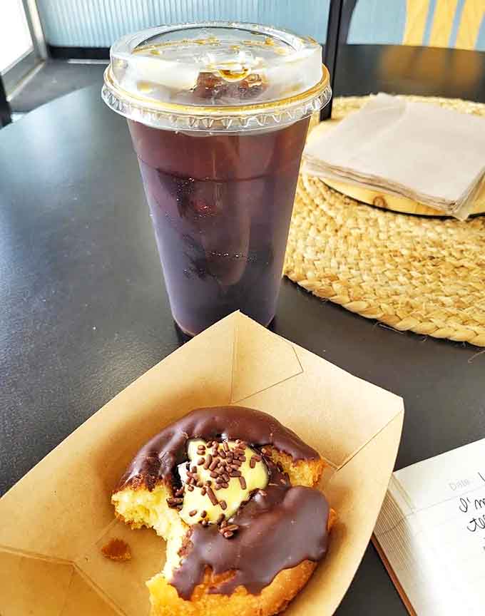 Chocolate Donut with Drink: The perfect pairing &ndash; rich chocolate donut meets robust coffee. Together they create a breakfast symphony that makes mornings worth facing.