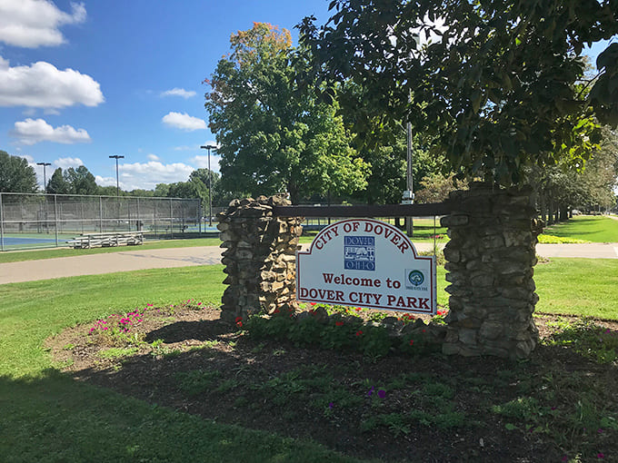 The welcoming stone entrance to Dover City Park promises family memories waiting to be made among its green spaces.