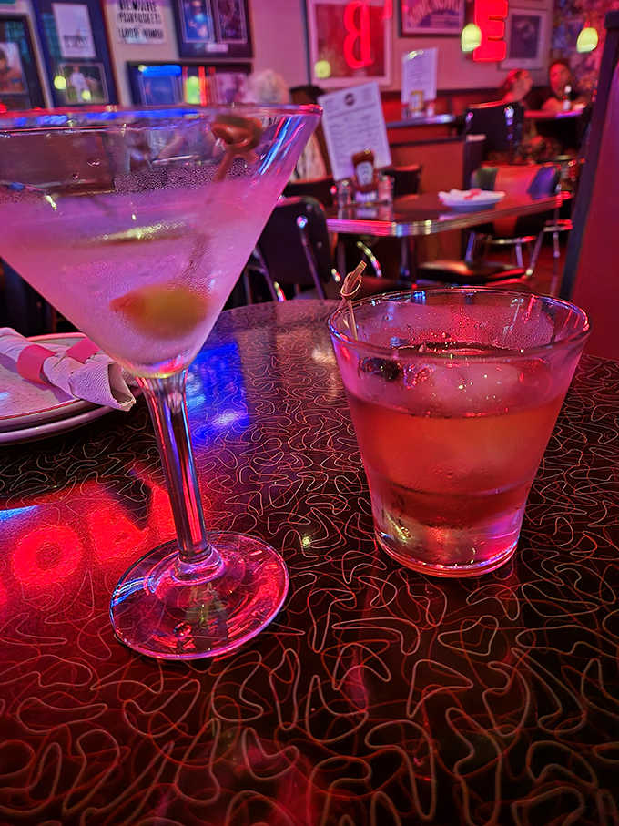 Crystal clear martini meets amber old-fashioned under the rosy glow of bar lights&mdash;liquid art waiting to be sipped, not gulped.