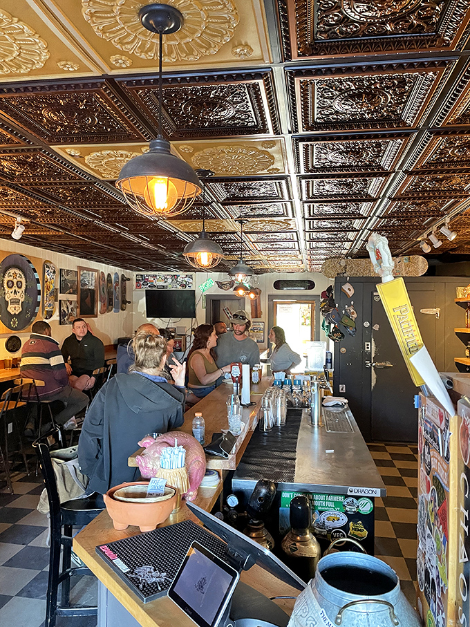The bar area buzzes with locals and visitors alike, all united under the ornate tin ceiling by their quest for exceptional tacos.