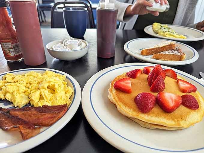 Pancakes topped with fresh strawberries prove that sometimes the simplest presentations are the most beautiful, especially when they taste this good.