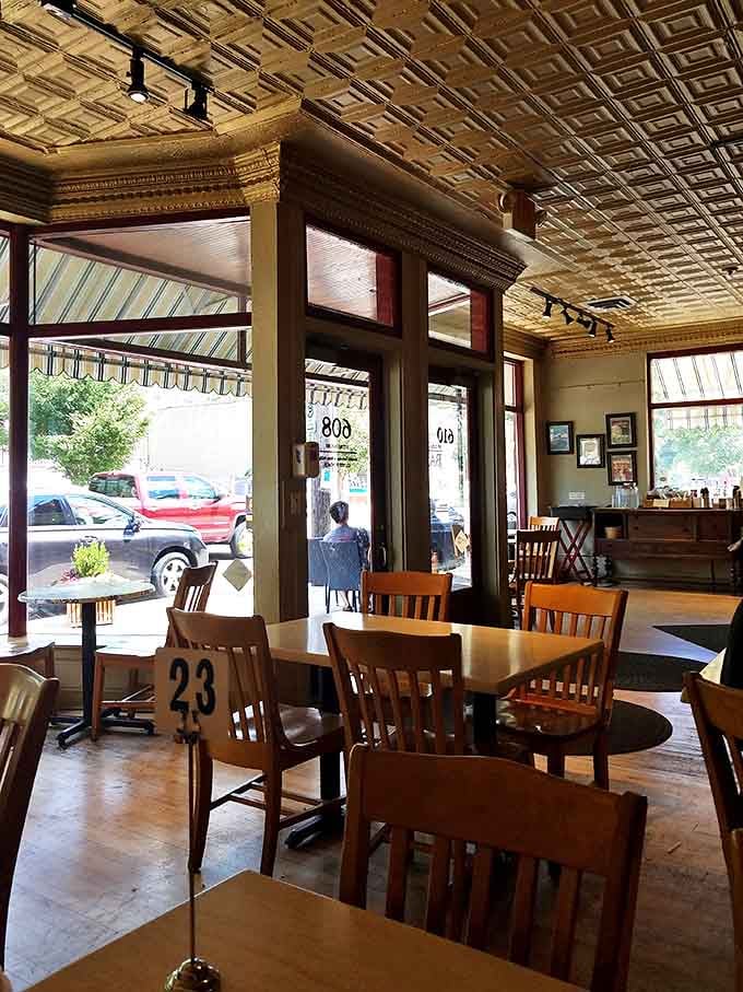 Where conversations happen and community thrives &ndash; wooden chairs, numbered tables, and the kind of atmosphere that makes you want to linger over that second coffee.