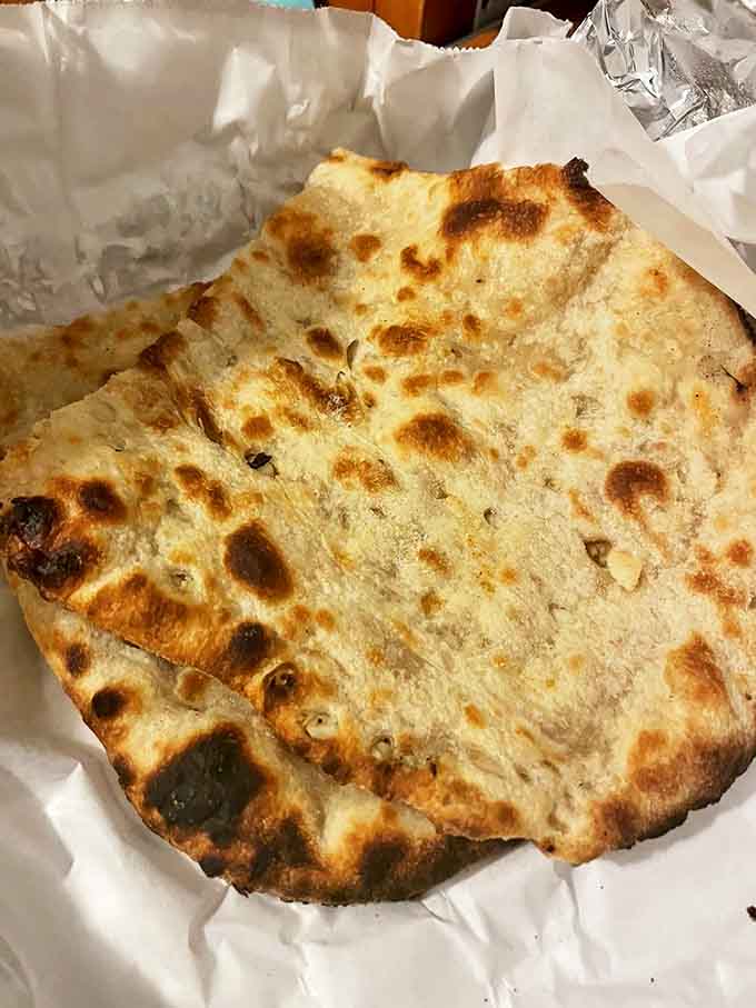 Freshly baked naan with those perfect char marks &ndash; the ideal edible utensil for scooping up every last drop of curry.