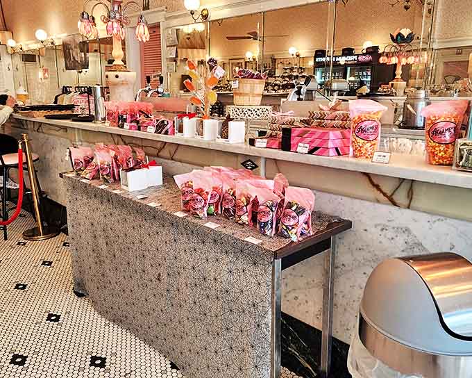 Pretty pink packages line the counter, ready to transform an ordinary day into something special for lucky recipients.