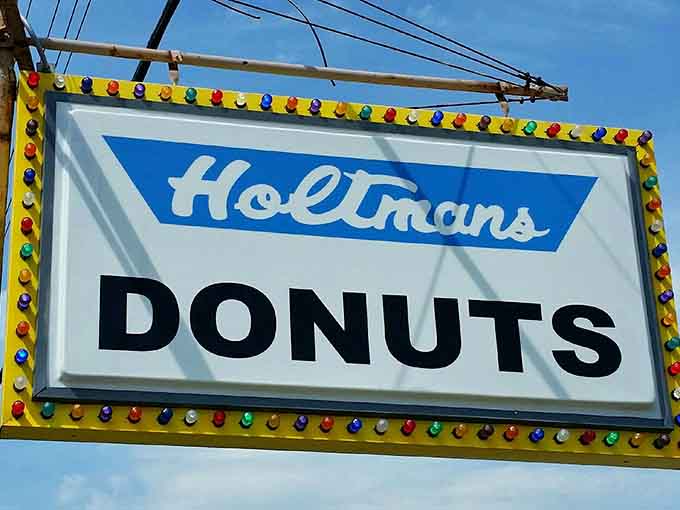 That vintage-style sign beckons like a lighthouse guiding ships, except it's guiding you to maple bacon donut paradise instead.