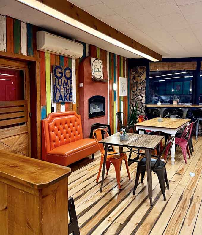 The bar area features colorful tractor seats and quirky signs that reinforce the restaurant's playful, welcoming personality throughout.