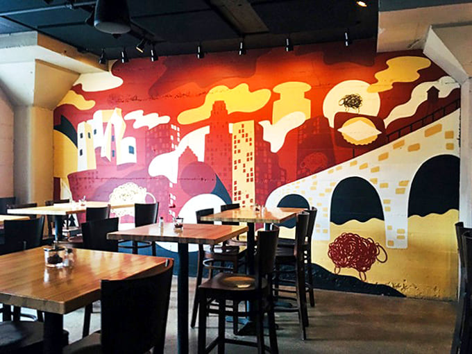 That vibrant mural transforms an ordinary wall into a conversation piece &ndash; urban art meets comfort food in perfect harmony.