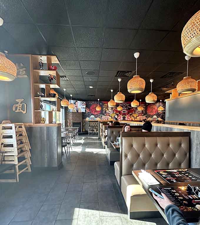 Vibrant murals depicting traditional Japanese imagery create visual interest while maintaining the restaurant's warm, welcoming atmosphere throughout the space.