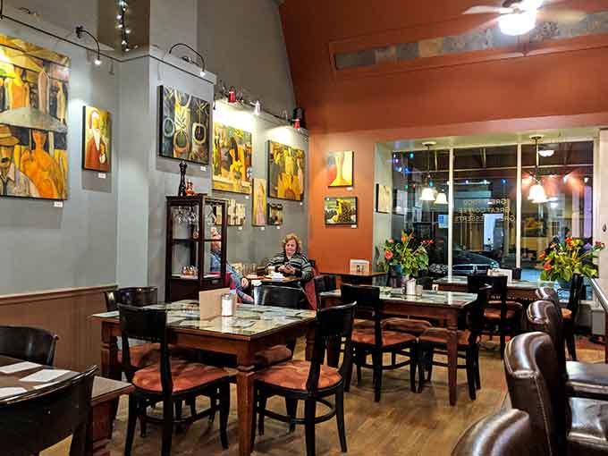 Dining tables arranged to encourage conversation while local art adds pops of color to the walls.