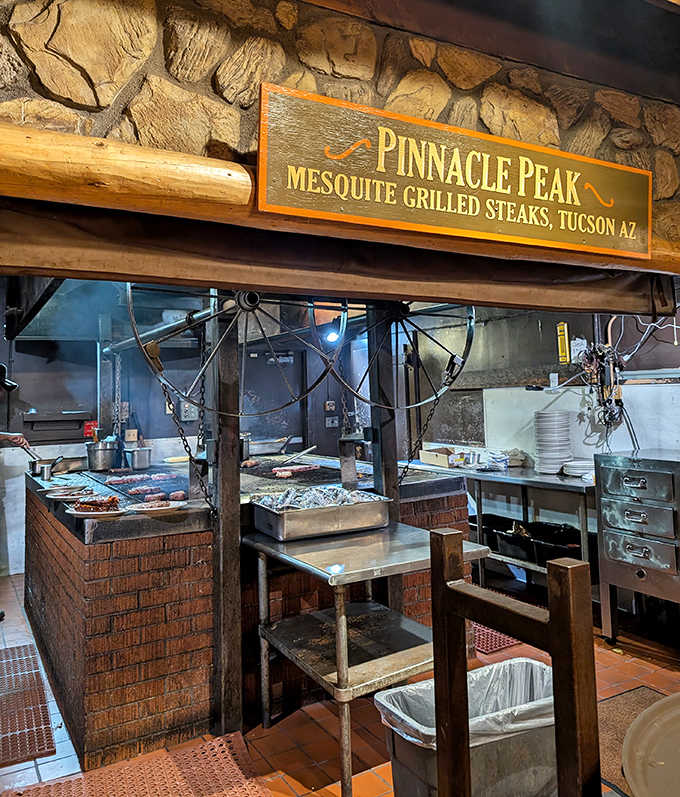 The open kitchen reveals the heart of Pinnacle Peak's operation &ndash; mesquite grills where steaks are transformed into legendary meals.