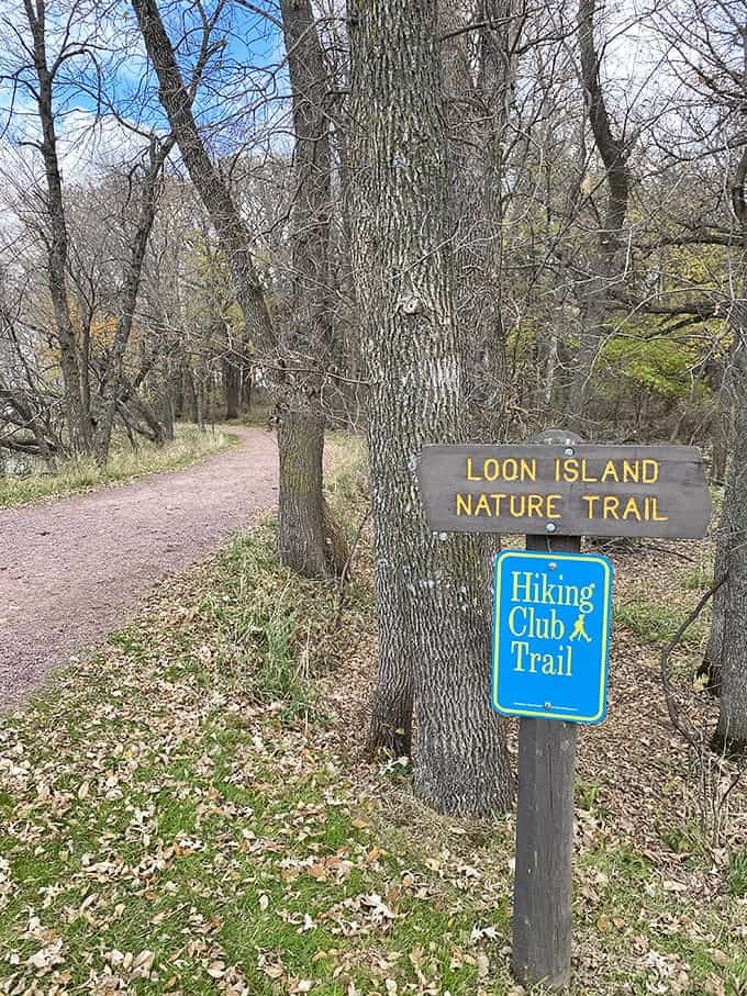 Trail signs pointing toward Loon Island promise the kind of nature walk that delivers exactly what you're hoping for when you visit a state park.l.
