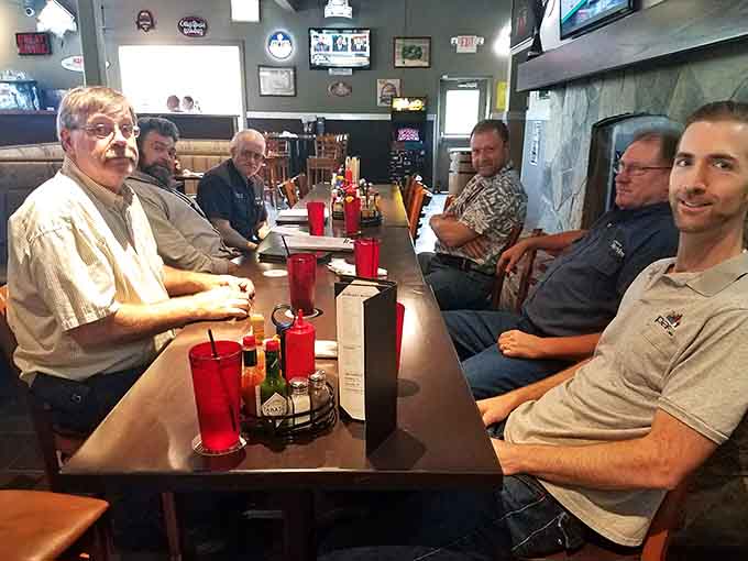 Happy diners gathered around the table, proof that good food brings people together every time.