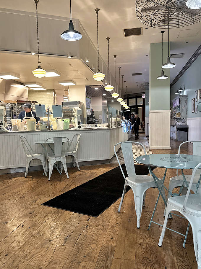 Pendant lights and white metal chairs create a space that invites you to slow down and remember what enjoying dessert really means.