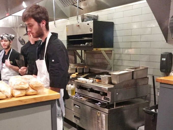 Outdoor dining under blue canopies offers a casual alternative for enjoying Main Street Farmer's creations in Minnesota's fleeting summer weather.