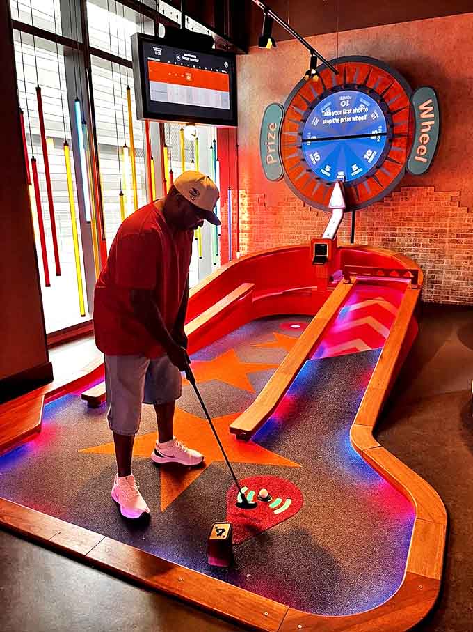 Perfect form meets playful design as this golfer takes aim on a course where traditional putting skills meet unpredictable technological twists.