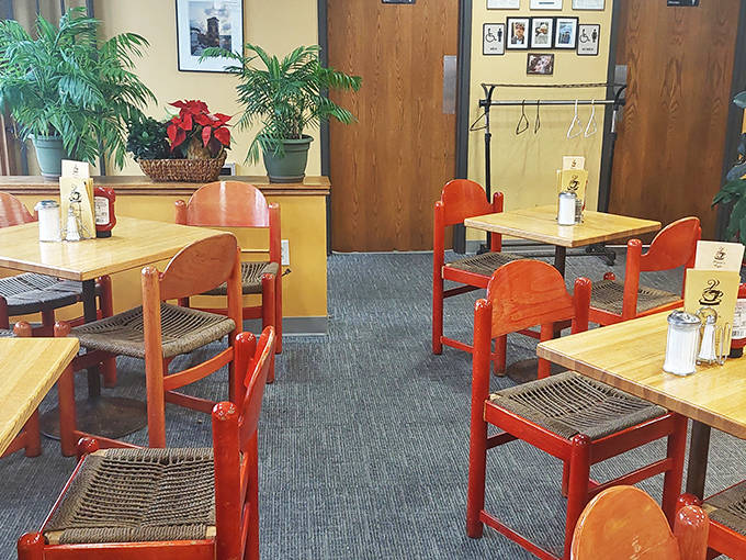 The thoughtfully arranged dining area features comfortable seating, potted plants, and plenty of natural light—creating a space where lingering over coffee feels not just allowed but encouraged.
