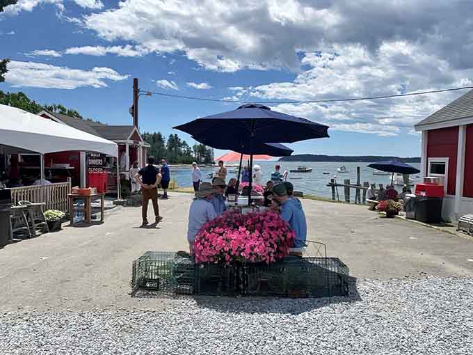 Happy diners enjoying their seafood feast with harbor views&mdash;this is exactly what summer in Maine is supposed to look like.