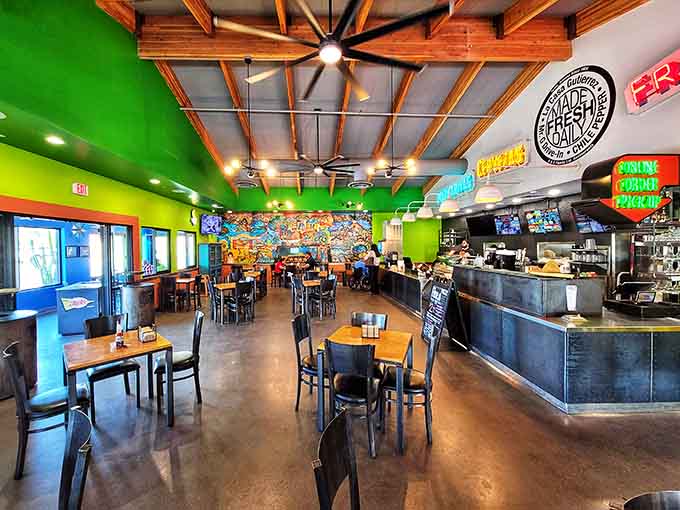 The spacious dining area with colorful booths and simple tables creates a welcoming space where everyone from families to solo diners feels at home.