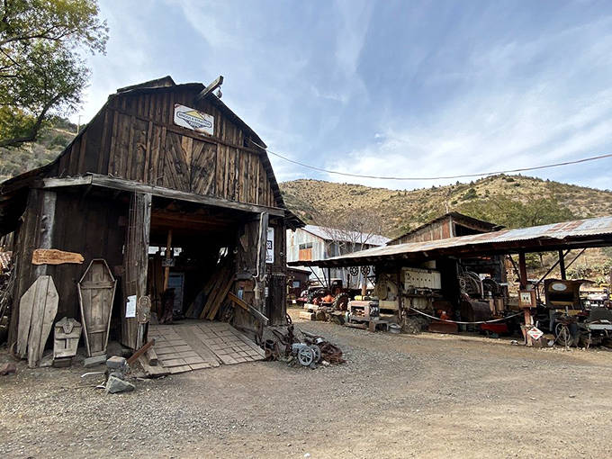 The old wood mill's weathered barn structure housed essential carpentry operations &ndash; every mining town needed builders and lumber.