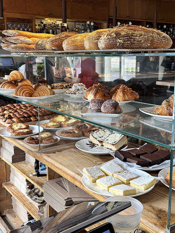 Pastry paradise: the display case showcases flaky croissants, rustic breads, and sweet treats that make choosing just one nearly impossible.