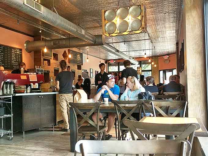 Patisserie 46 buzzes with energy as patrons savor moments of culinary bliss, the pressed tin ceiling reflecting warm light throughout.