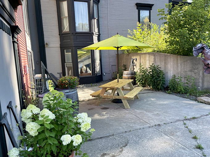 The sunny outdoor patio offers a peaceful respite for weary treasure hunters, where Vermont's fresh air helps clear minds for the next discovery.