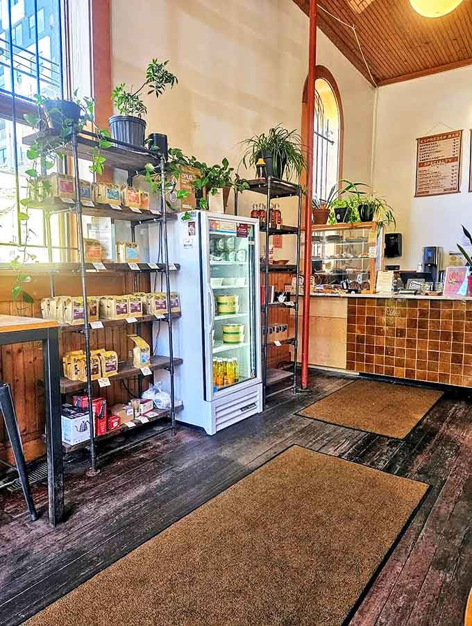 Coffee beans and brewing supplies line industrial shelves like a caffeinated apothecary. Everything you need to attempt greatness at home.