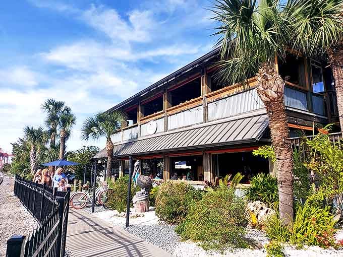 Salty Pelican Bar & Grill sits right on the water where the deck practically hangs over the marsh, making every meal feel like a celebration.
