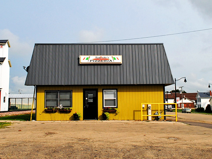 Saporito's sunny yellow exterior brightens the landscape, promising pizza perfection inside its humble walls.