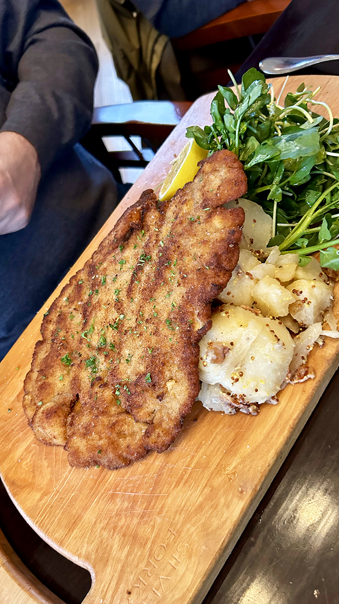 The Wiener Schnitzel arrives golden and crisp, accompanied by German potato salad &ndash; a plate that transports you straight to Vienna without leaving Vermont.
