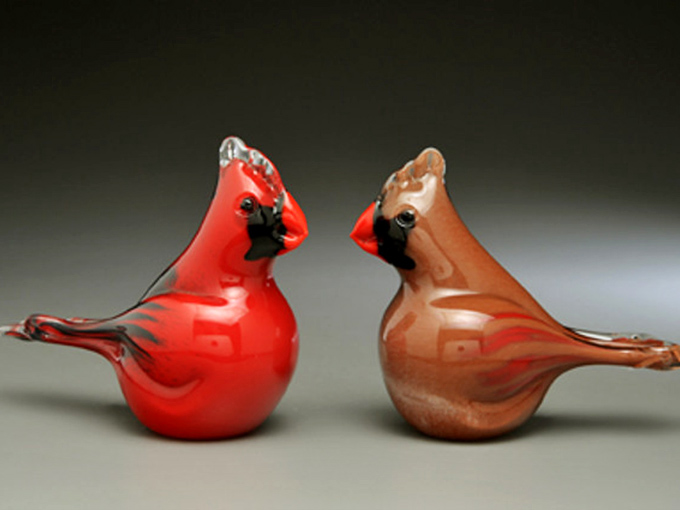 Delicate glass cardinal figurines capture Vermont's wildlife spirit, handcrafted by artisans continuing the region's tradition of fine craftsmanship.