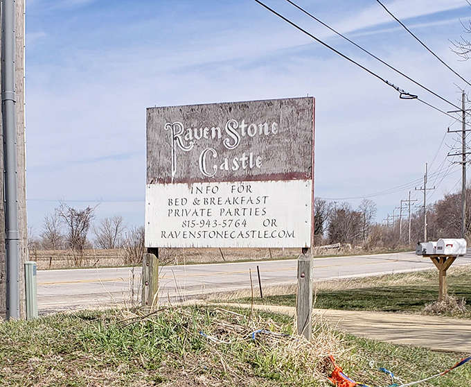 The weathered sign points the way to unexpected adventure, a humble herald for the magnificent structure that awaits visitors.