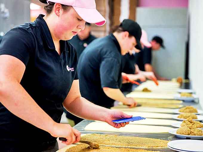 Craftsmanship in action: staff members transform simple ingredients into extraordinary treats, their movements a choreography of baking expertise.
