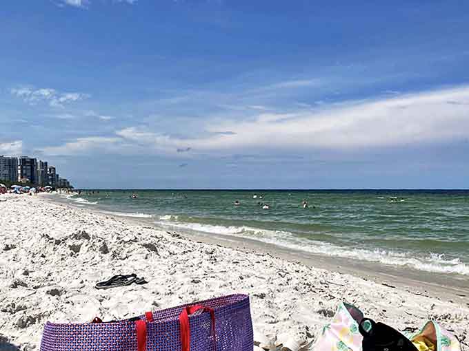 The sunny beach coastline stretches invitingly, promising a day of perfect relaxation or ambitious sandcastle engineering.