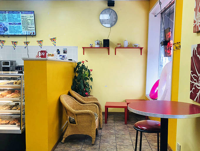 Bright orange tables pop against neutral walls, creating a cheerful spot to contemplate life's important questions&mdash;like which donut to try next.