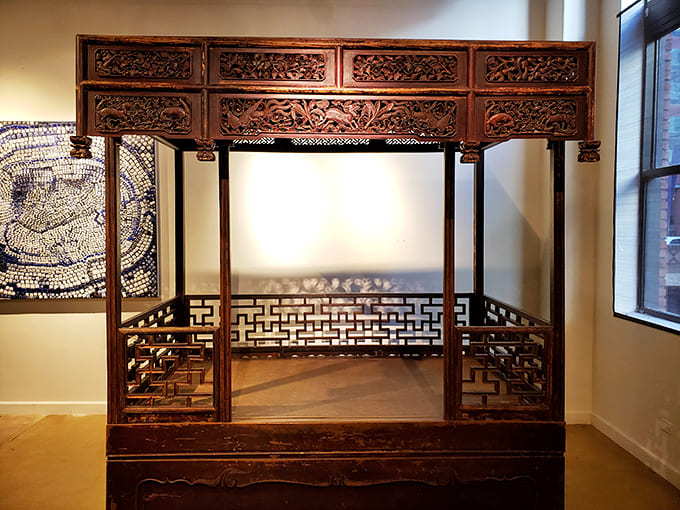 An antique Chinese canopy bed that's probably hosted more interesting dreams than your current IKEA frame ever will.