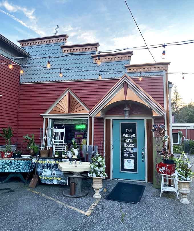 The Vintage Farm House glows with personality at dusk &ndash; its colorful facade hinting at the treasure trove of unique finds waiting inside.