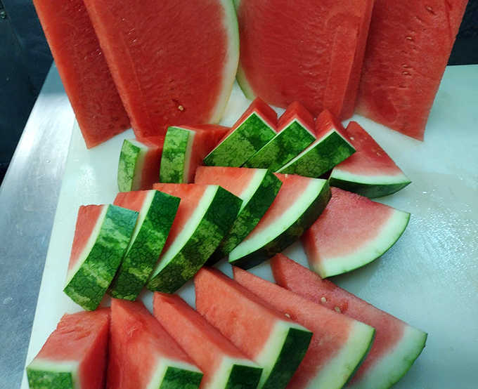 Fresh watermelon slices show the attention to detail that makes even simple sides special at this beloved local establishment.
