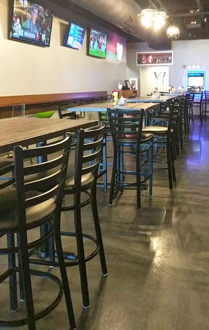 High-top seating and communal tables create a social atmosphere perfect for groups or solo diners.