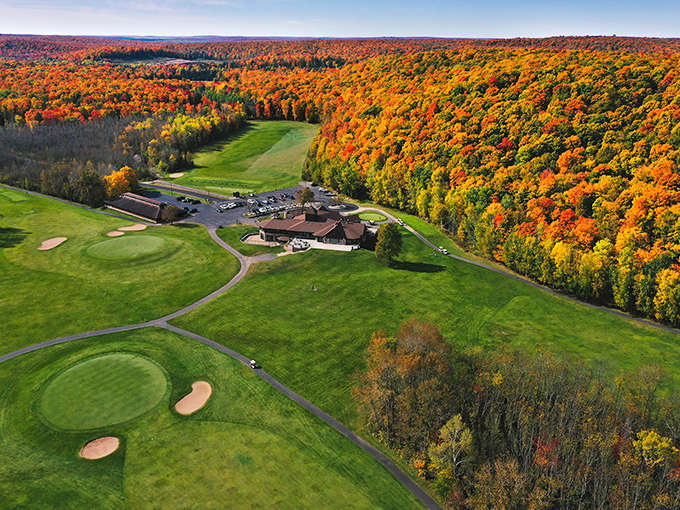 Young's Golf-Recreation-Dining: Where emerald fairways meet autumn's fiery display, creating a golfer's paradise nestled in nature's most spectacular color palette.