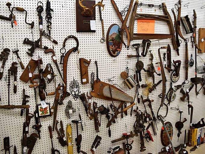 The wall of vintage tools showcases the craftsmanship that built America &ndash; each worn handle and rusted blade telling stories of creation and repair.
