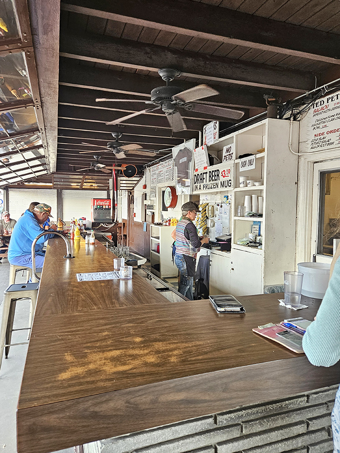 The bar area maintains that old Florida fish camp vibe &ndash; unpretentious, functional, and serving up cold drinks with friendly efficiency.